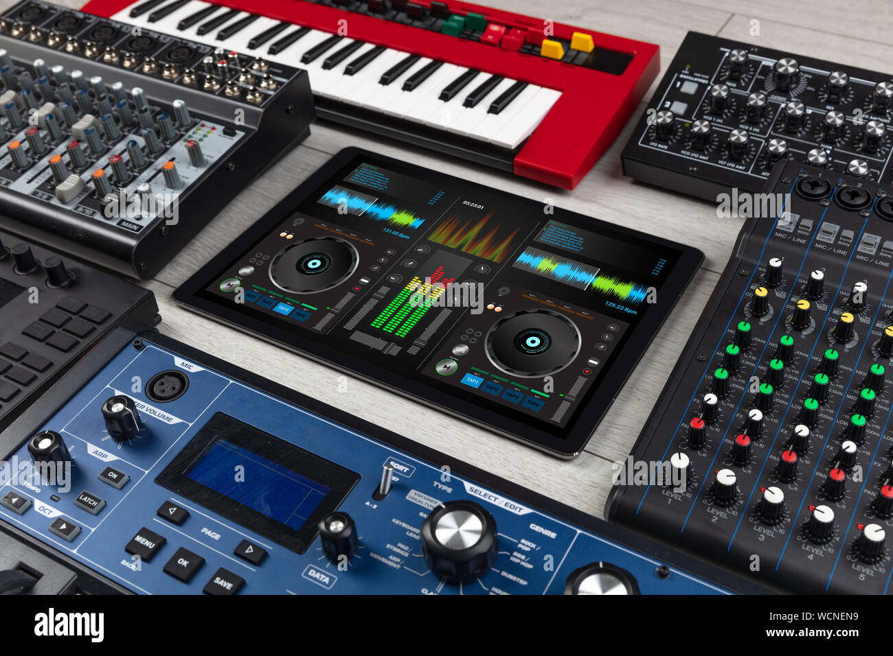 Mixing music on tablet with electronic music instruments concept Stock ...