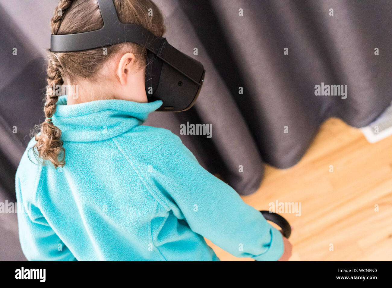 Little girl playing VR kids game in the living room Stock Photo - Alamy
