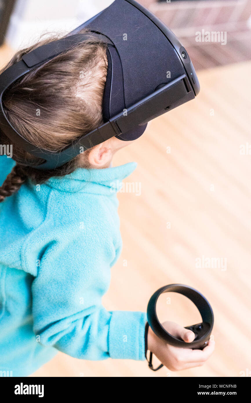 Little girl playing VR kids game in the living room Stock Photo - Alamy