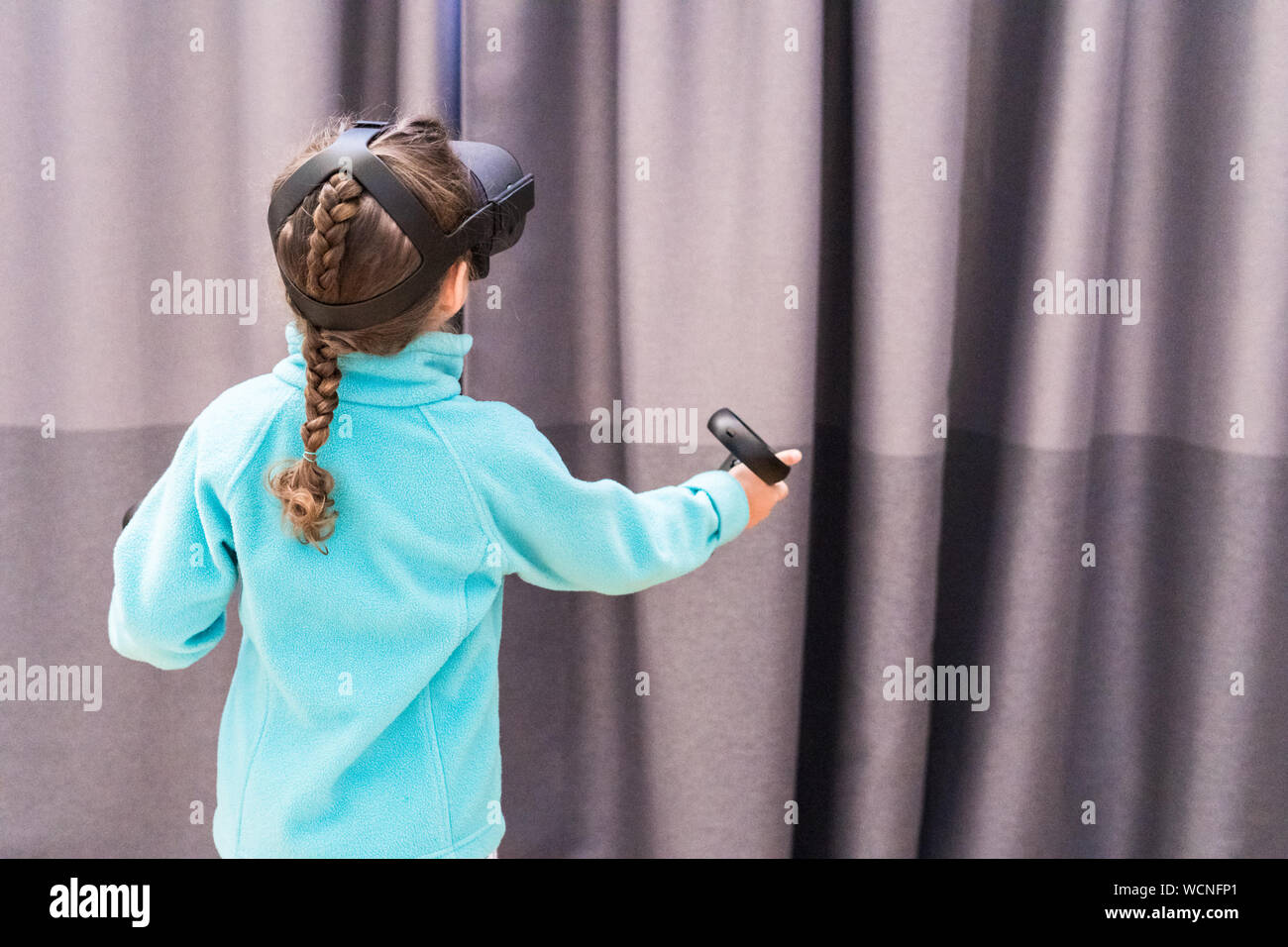 Little girl playing VR kids game in the living room Stock Photo - Alamy