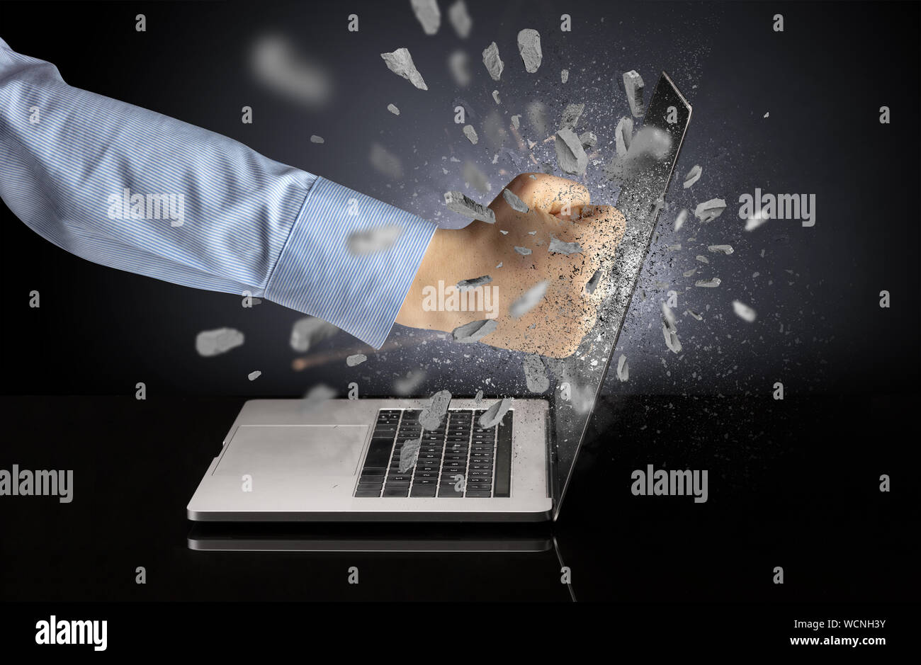 Strong male hand breaks laptop screen Stock Photo - Alamy