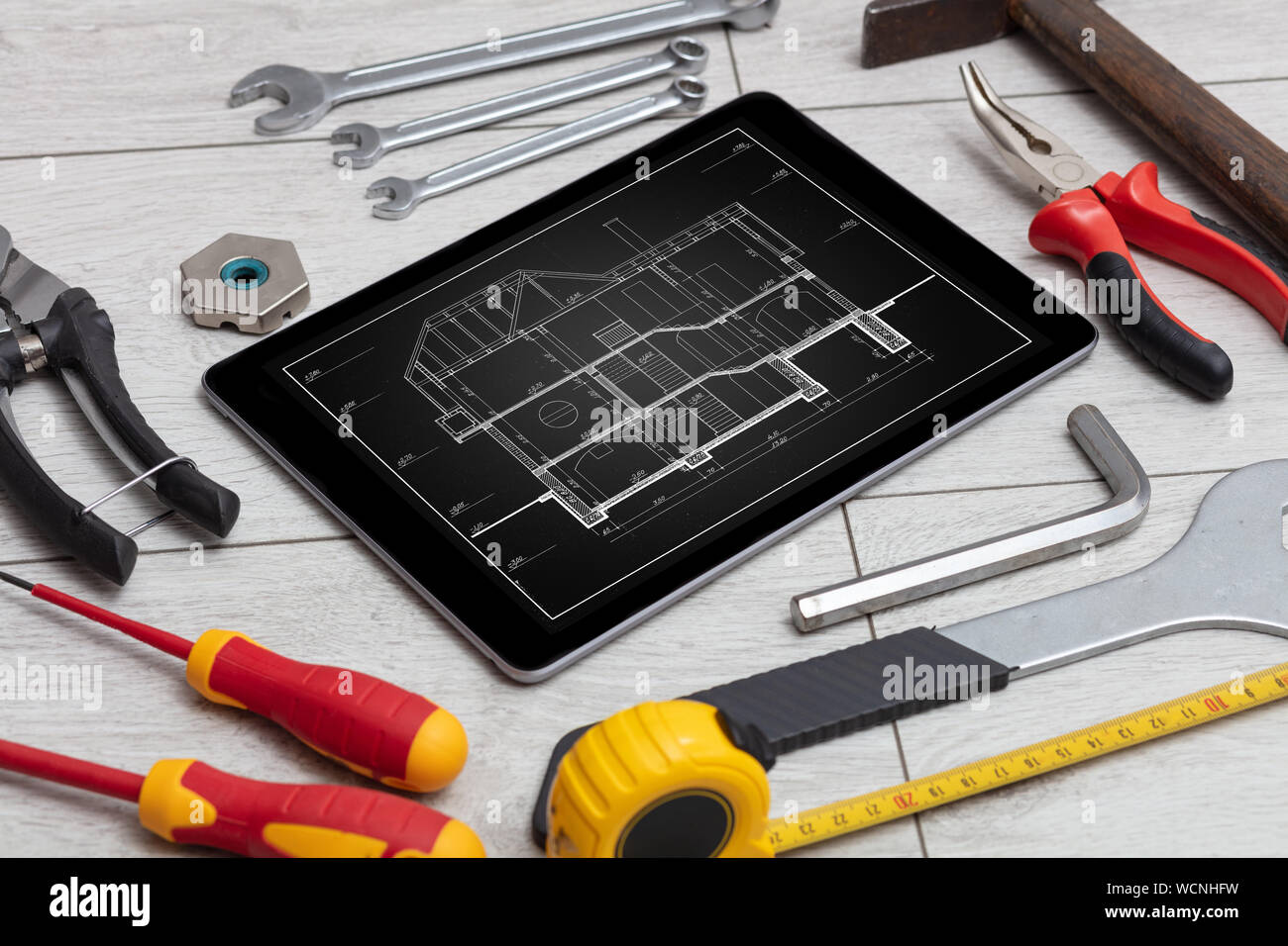 Tablet with construction tools and blueprint concept Stock Photo - Alamy