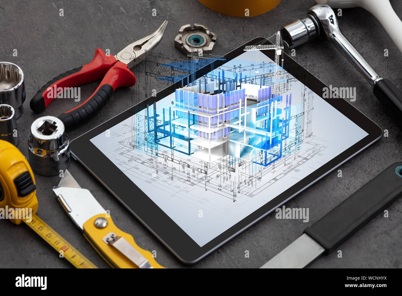 Tablet with construction tools and 3d house plan concept Stock Photo ...