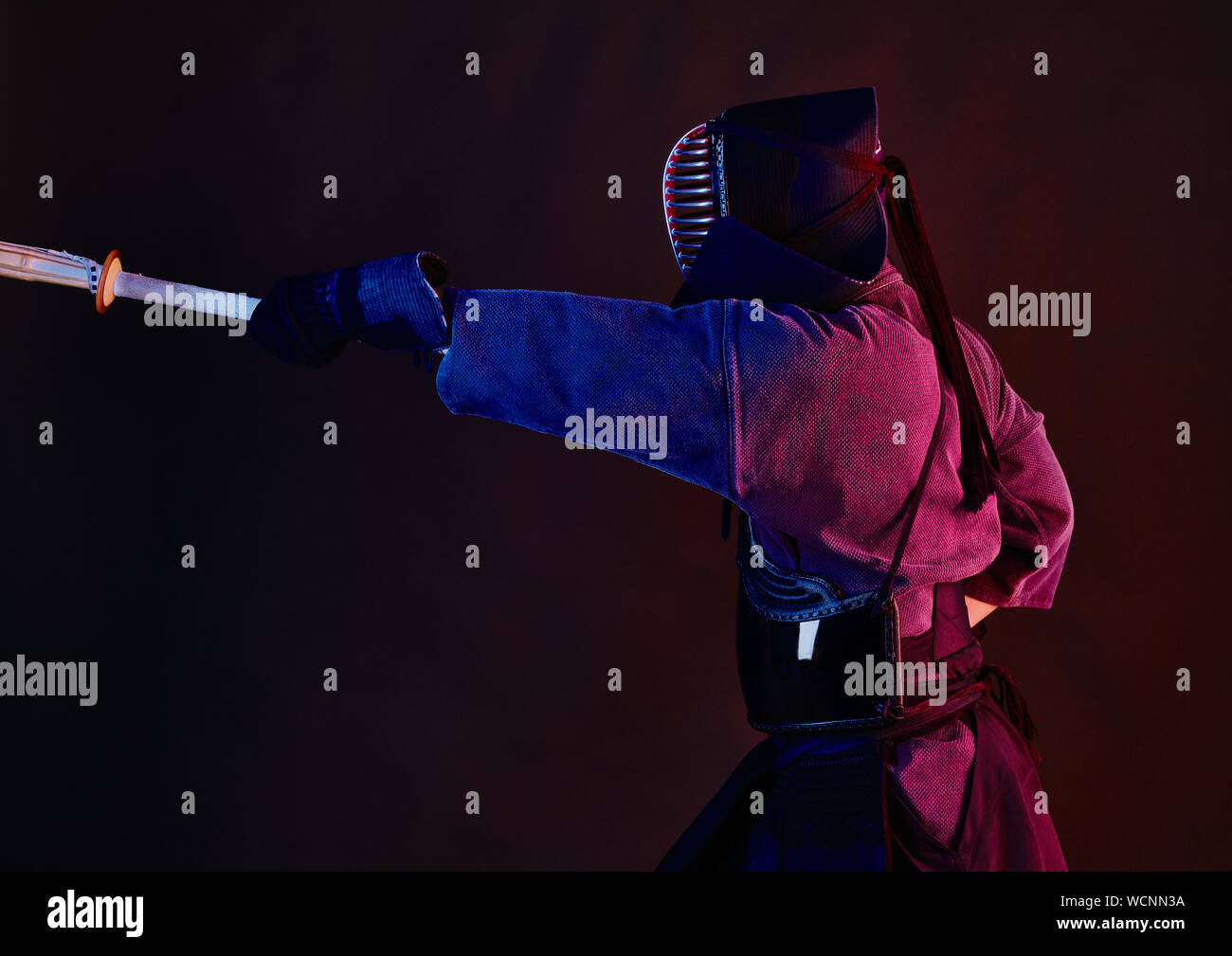 Concentrated Kendo master wearing in an armor, traditional kimono and ...