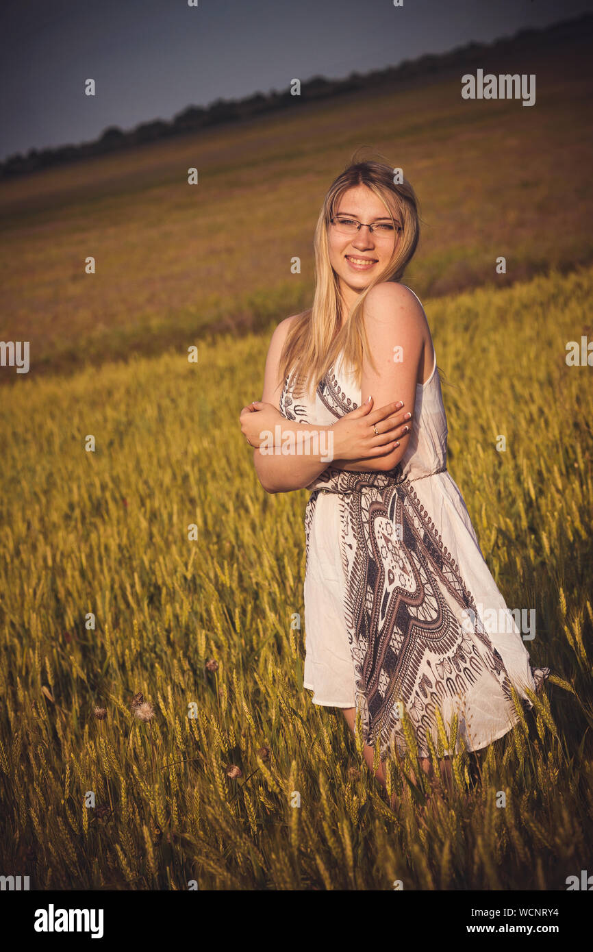 Healthy beautiful woman walking outdoors. Alluring young woman in wheat ...