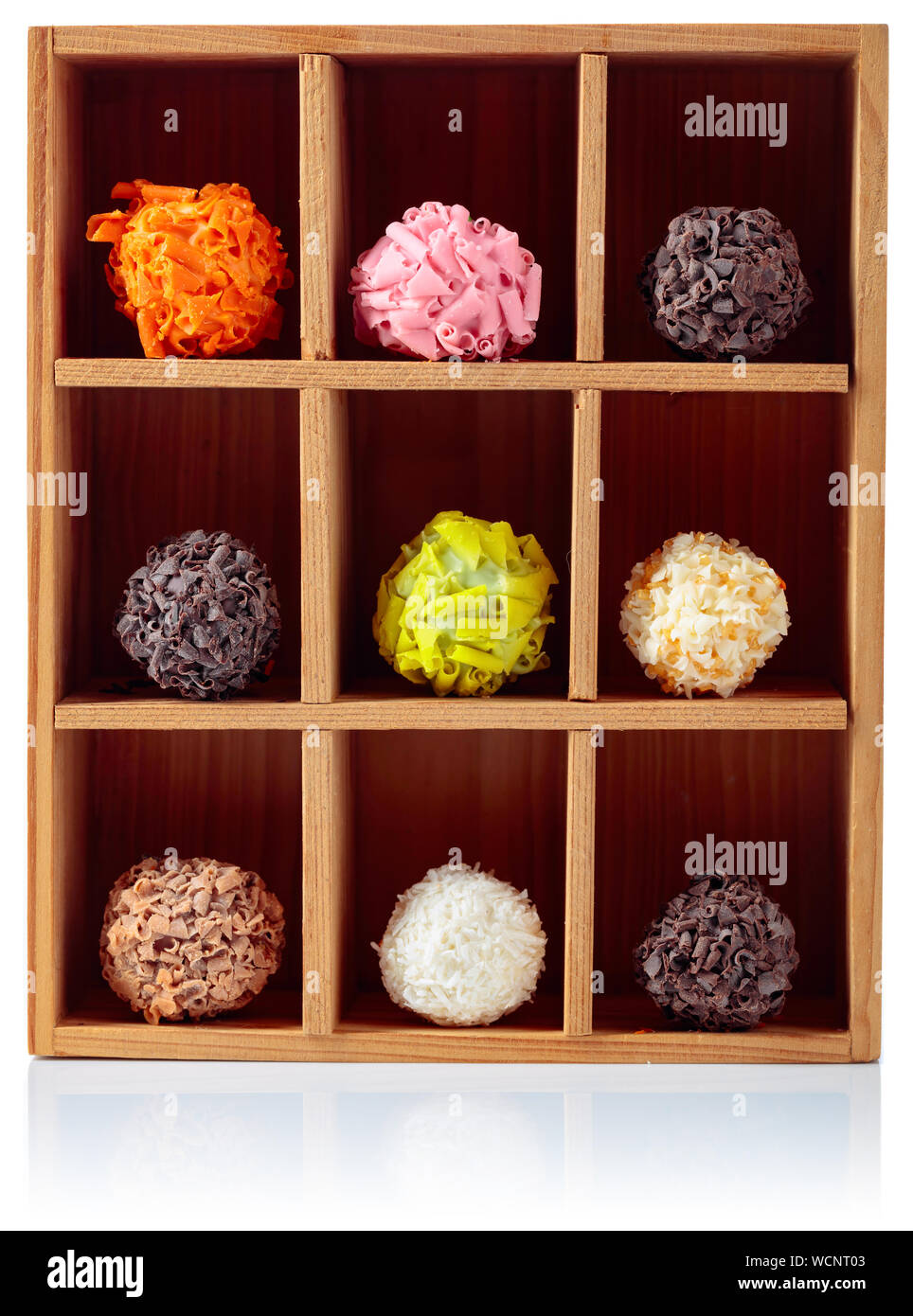Various colorful chocolate candy in wooden box Stock Photo - Alamy