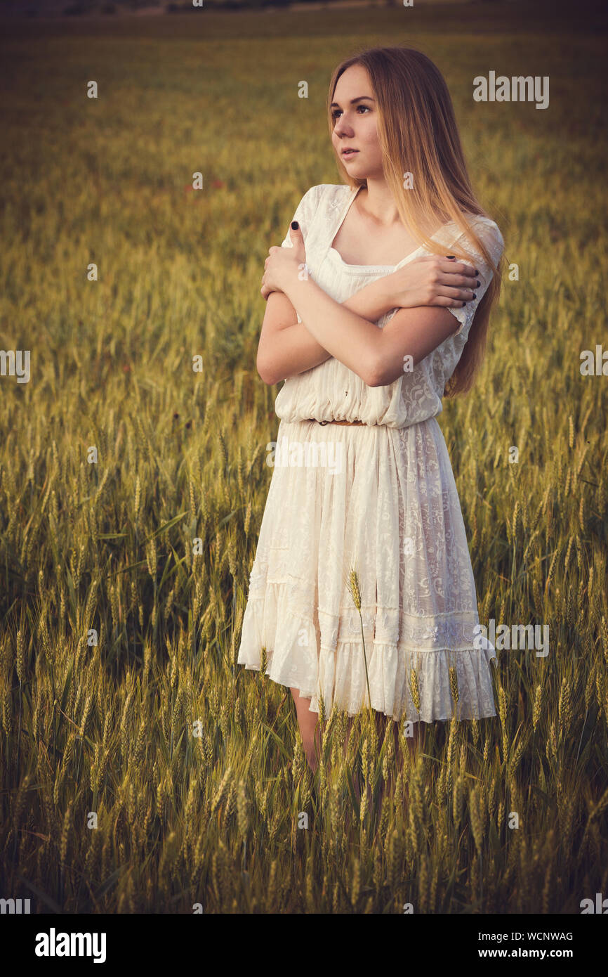 Healthy beautiful woman walking outdoors. Alluring young woman in wheat ...