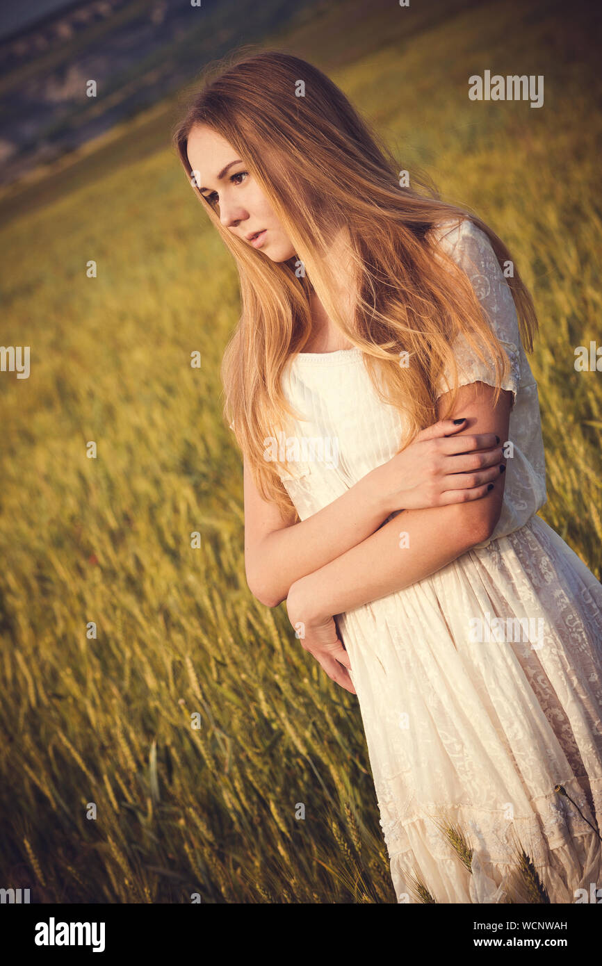 Healthy beautiful woman walking outdoors. Alluring young woman in wheat ...