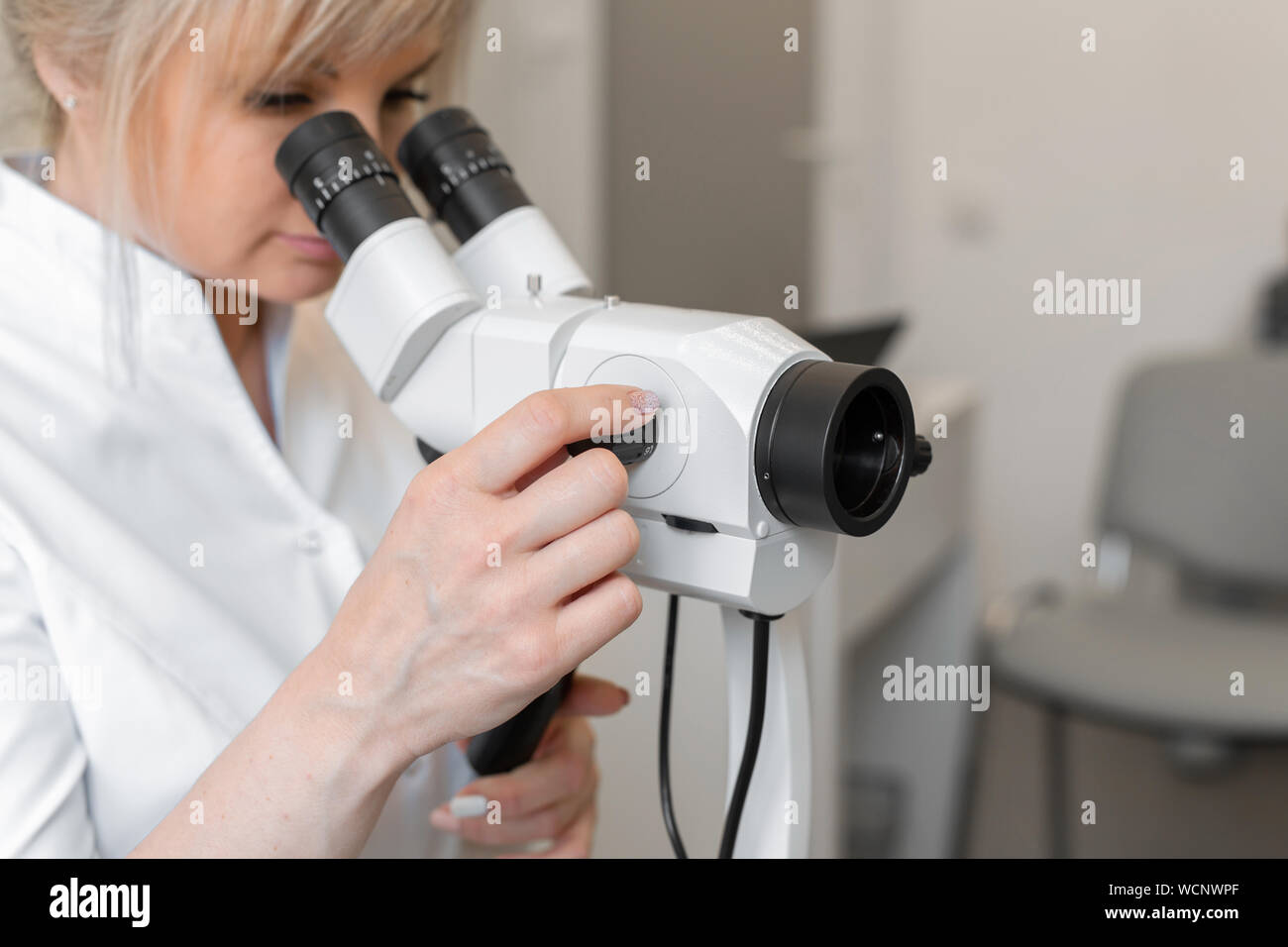 Young female professional gynecologist in the working process, looks ...