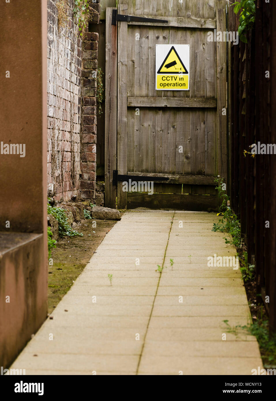 CCTV sign in passage way in residential area Stock Photo - Alamy