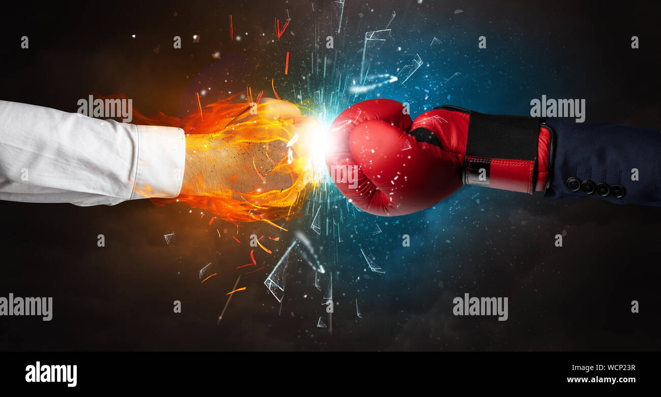 Two hands fighting and breaking glass into small pieces with fire and ...