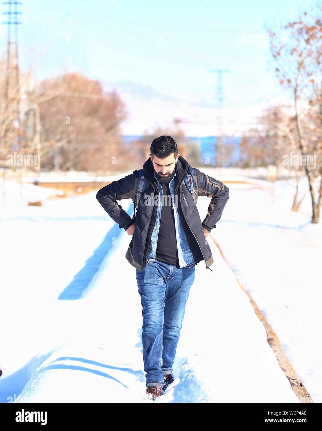 Young man walking in snow hi-res stock photography and images - Alamy