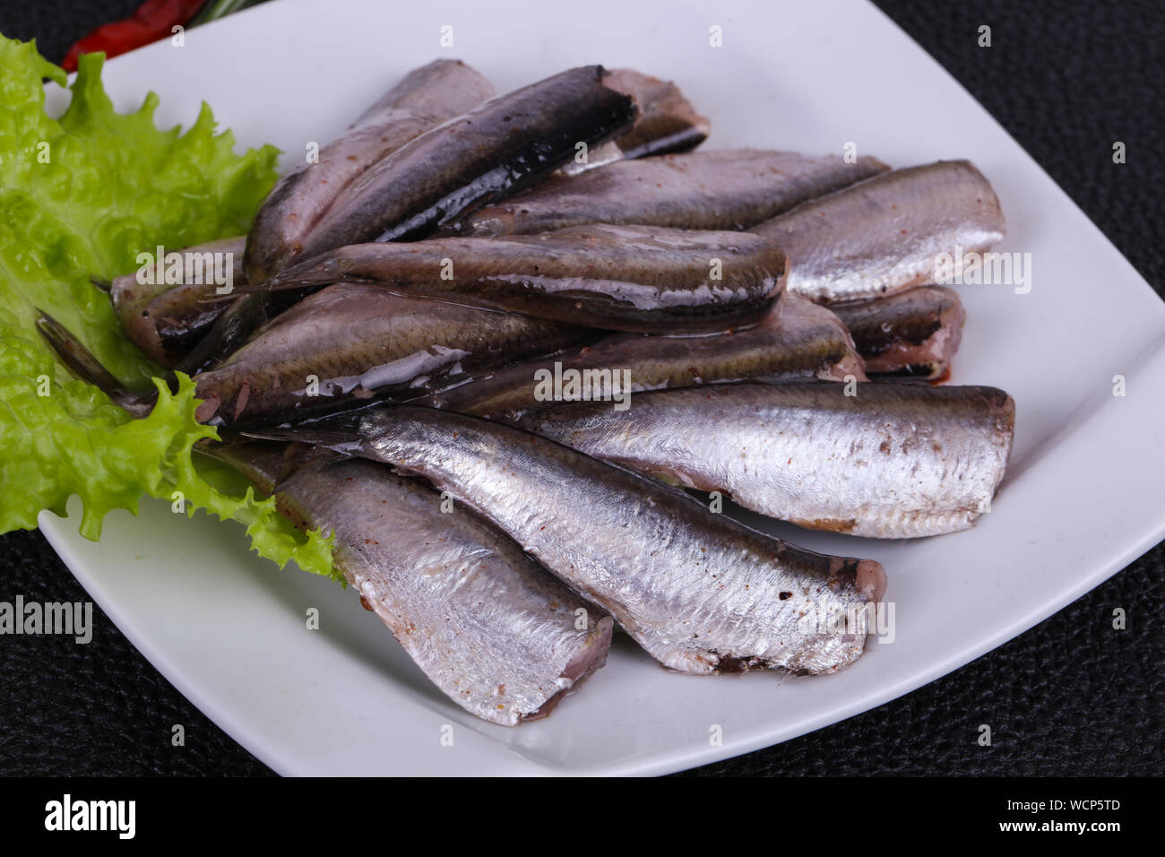Anchovy fish snack in the bowl served salad leaves and rosemary Stock ...