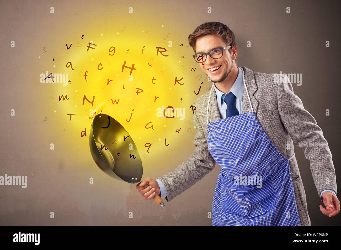 Young person cooking letters in wok Stock Photo - Alamy