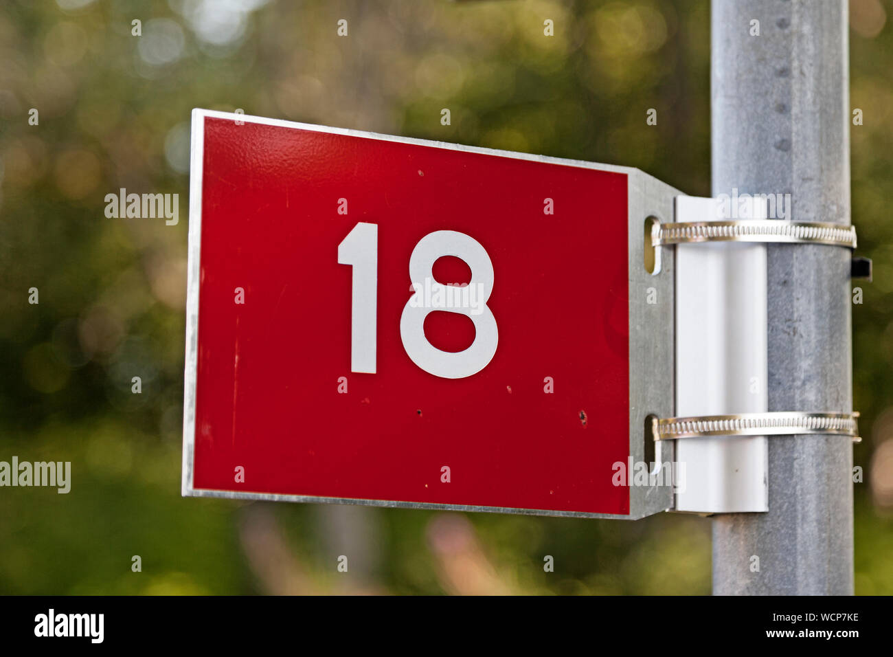 the figure eighteen on a red sign with white reflective text placed on ...