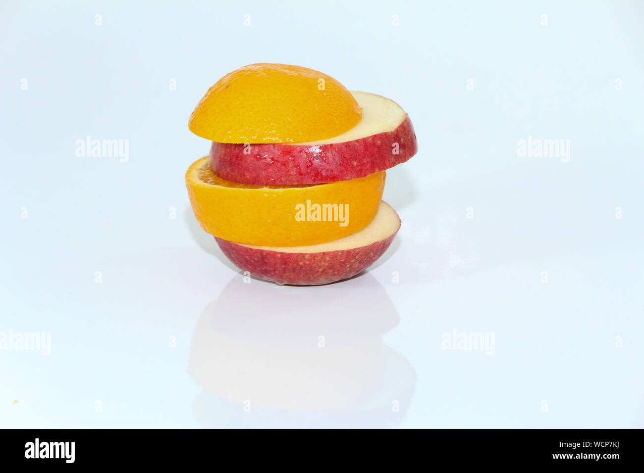 Stack Of Sliced Fruits Against White Background Stock Photo - Alamy