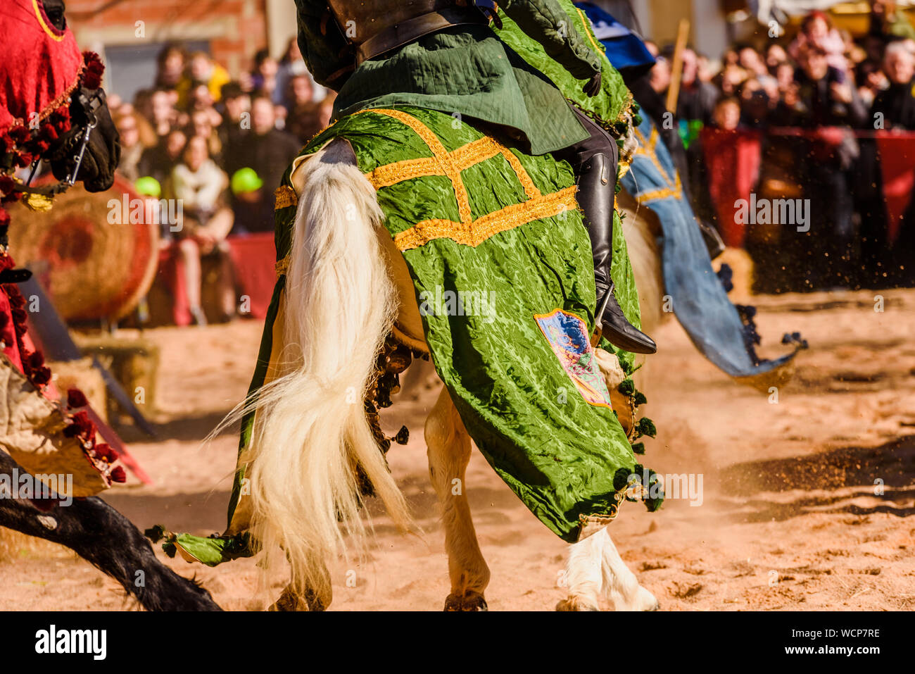 Detail of the legs of galloping horses adorned as medieval mounts ...