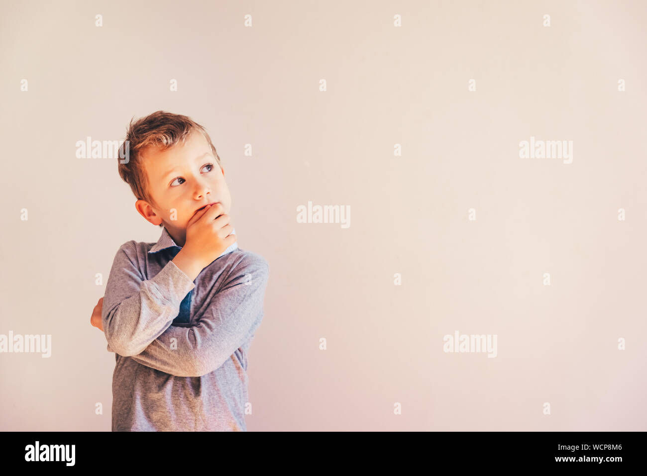 5 year old boy with very expressive thoughtful gesture, on white ...