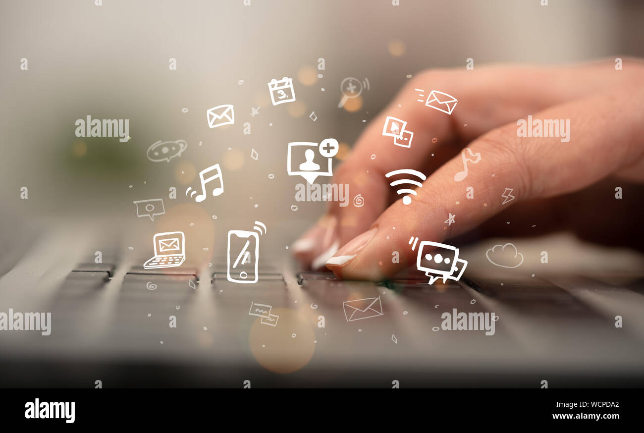 Business woman hand typing on keyboard with drawn application icons ...