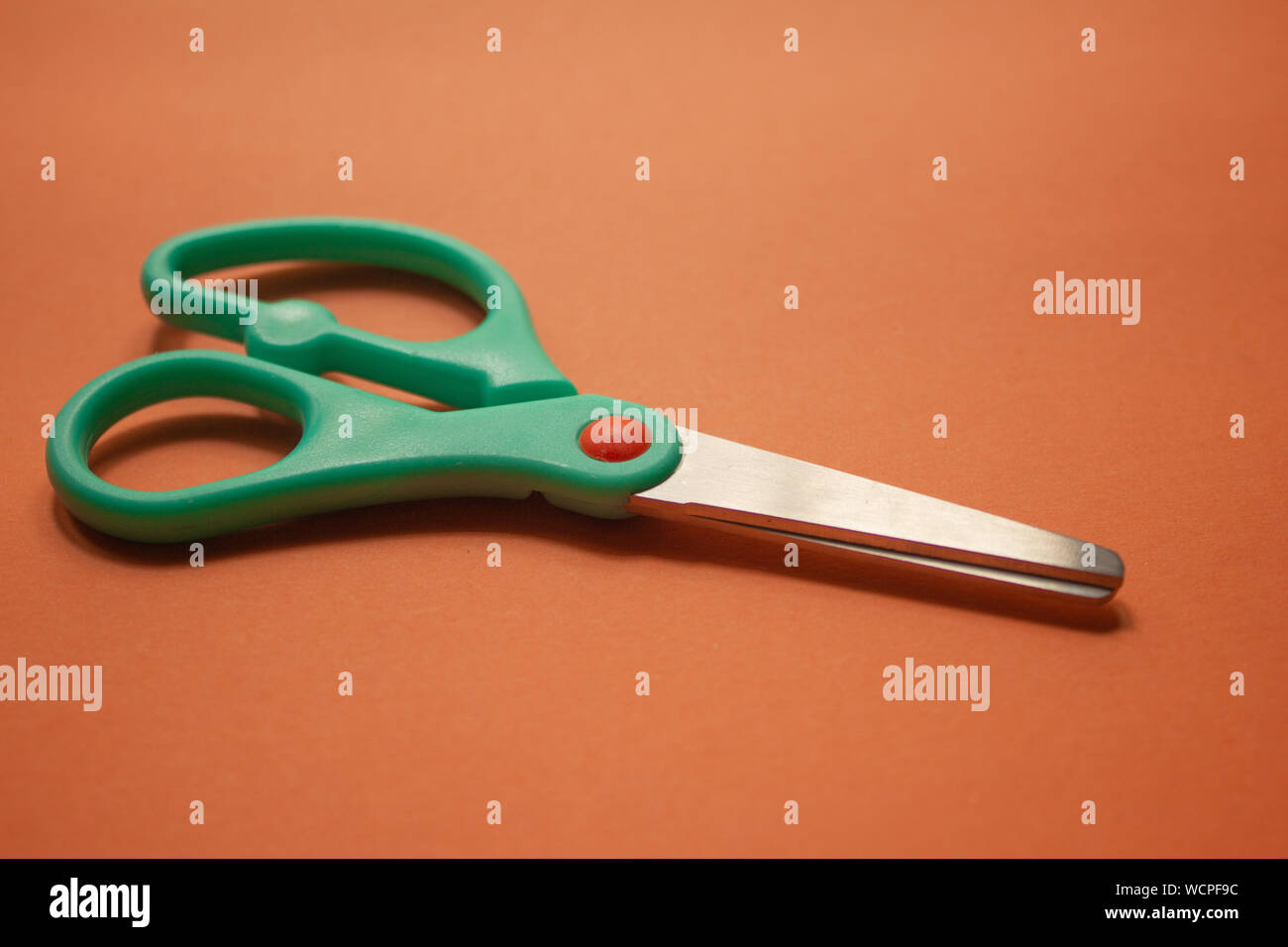 Child safe small scissor on plain background Stock Photo - Alamy
