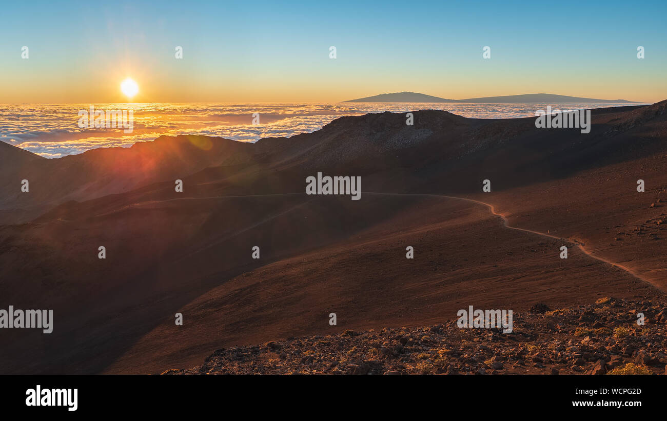 Sun rising over the sliding sands trail in Haleakala National Park ...