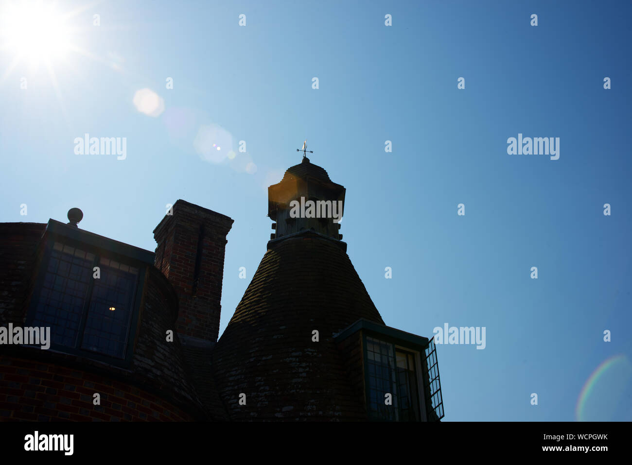 dovecot with lens flare blue sky Stock Photo - Alamy