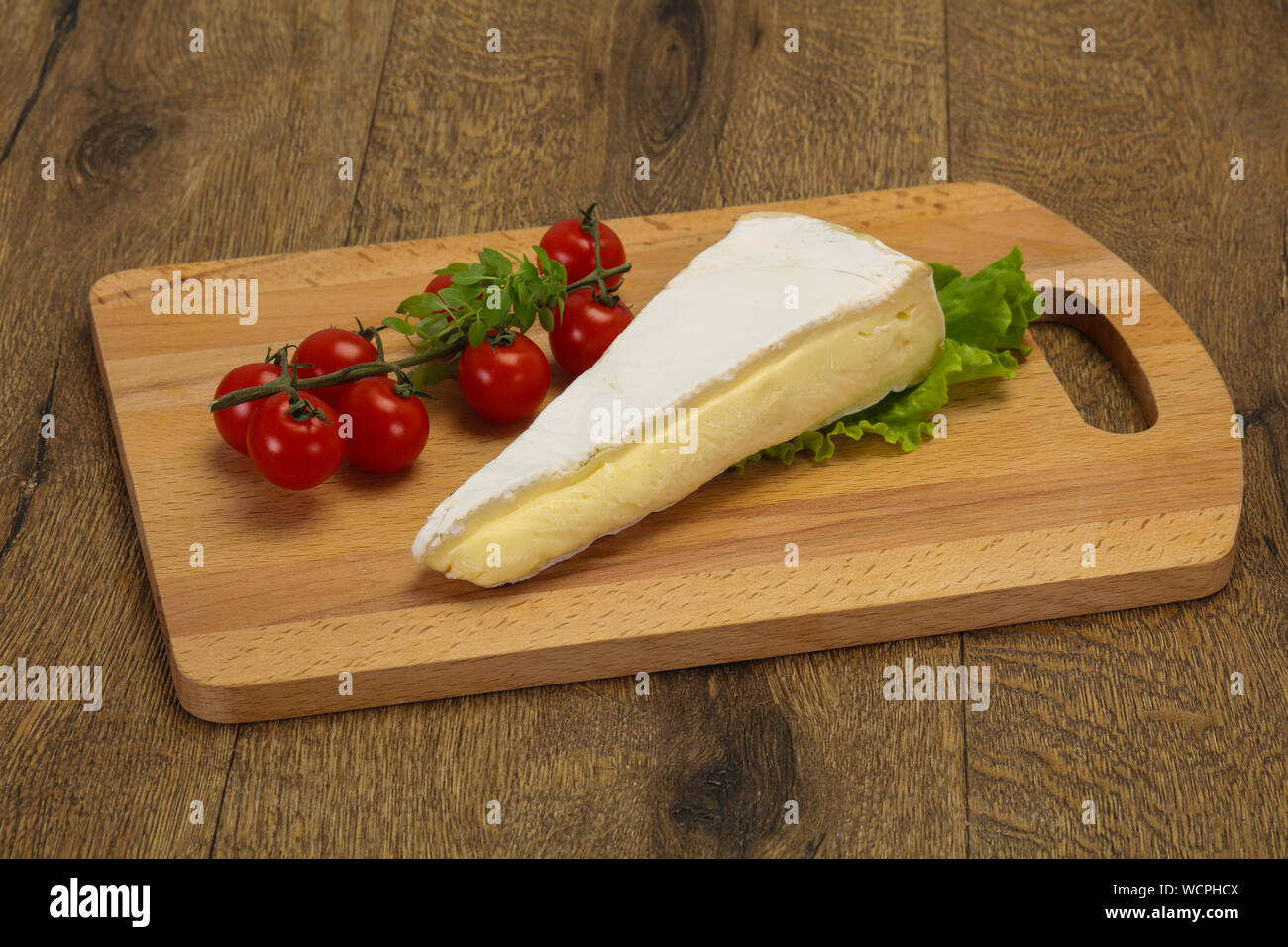 Brie cheese triangle served salad leaves Stock Photo - Alamy