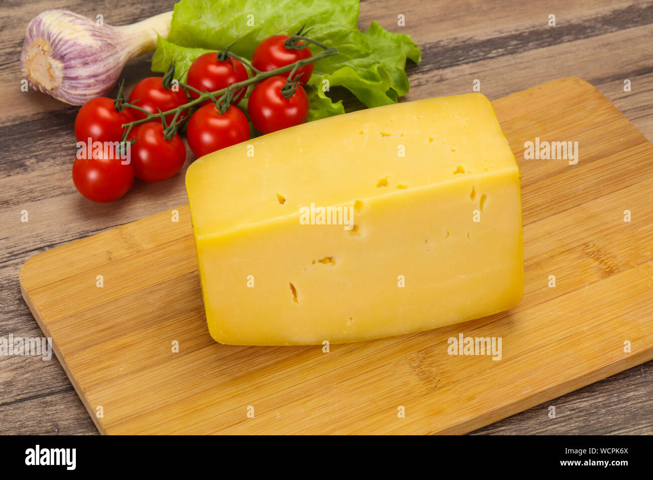 Swiss Hard yellow tasty cheese brick Stock Photo - Alamy