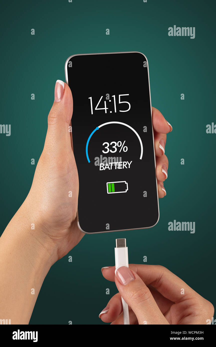 Elegant hand charging cellphone with low battery Stock Photo - Alamy