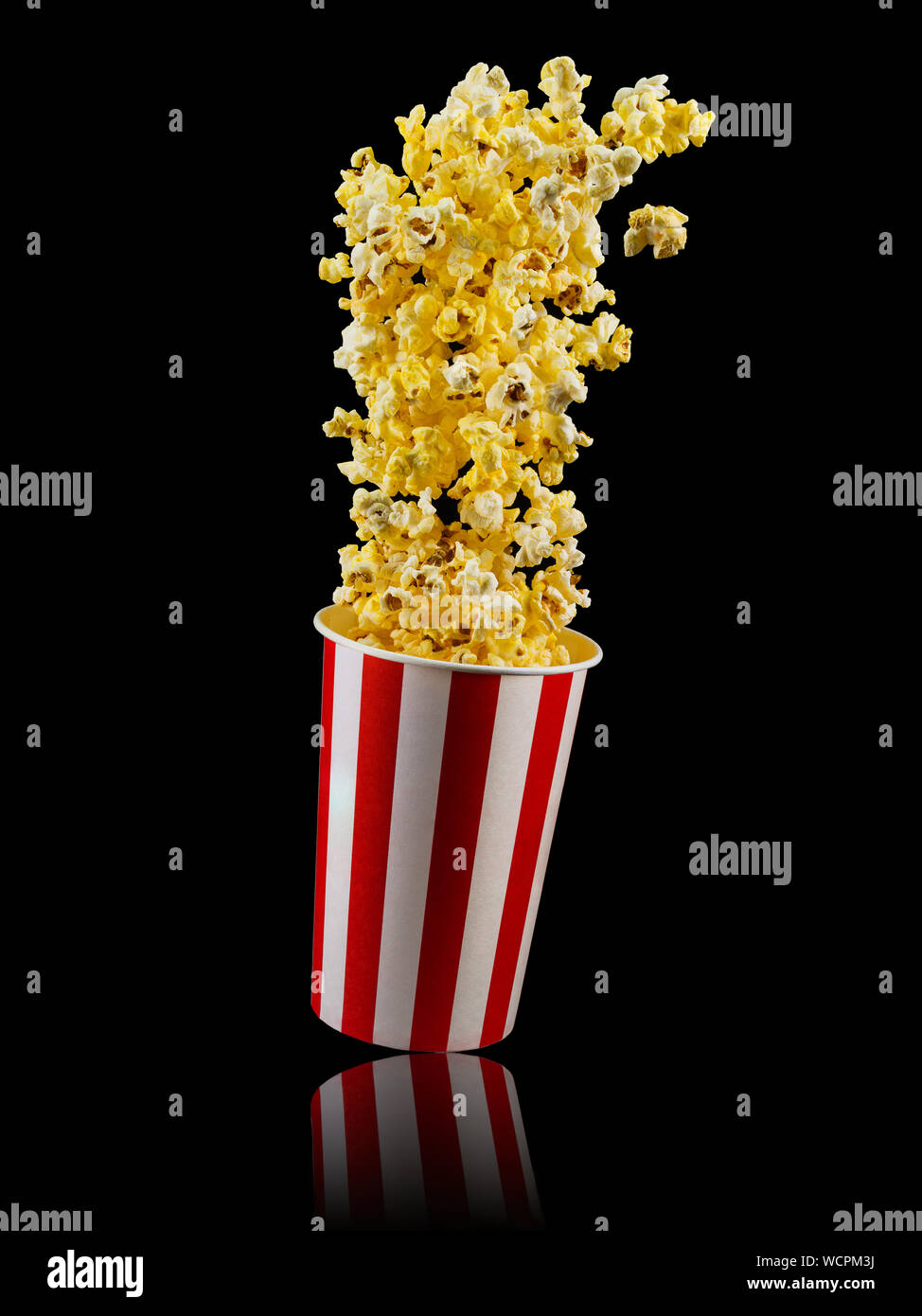 Paper striped bucket with popcorn isolated on black background Stock ...