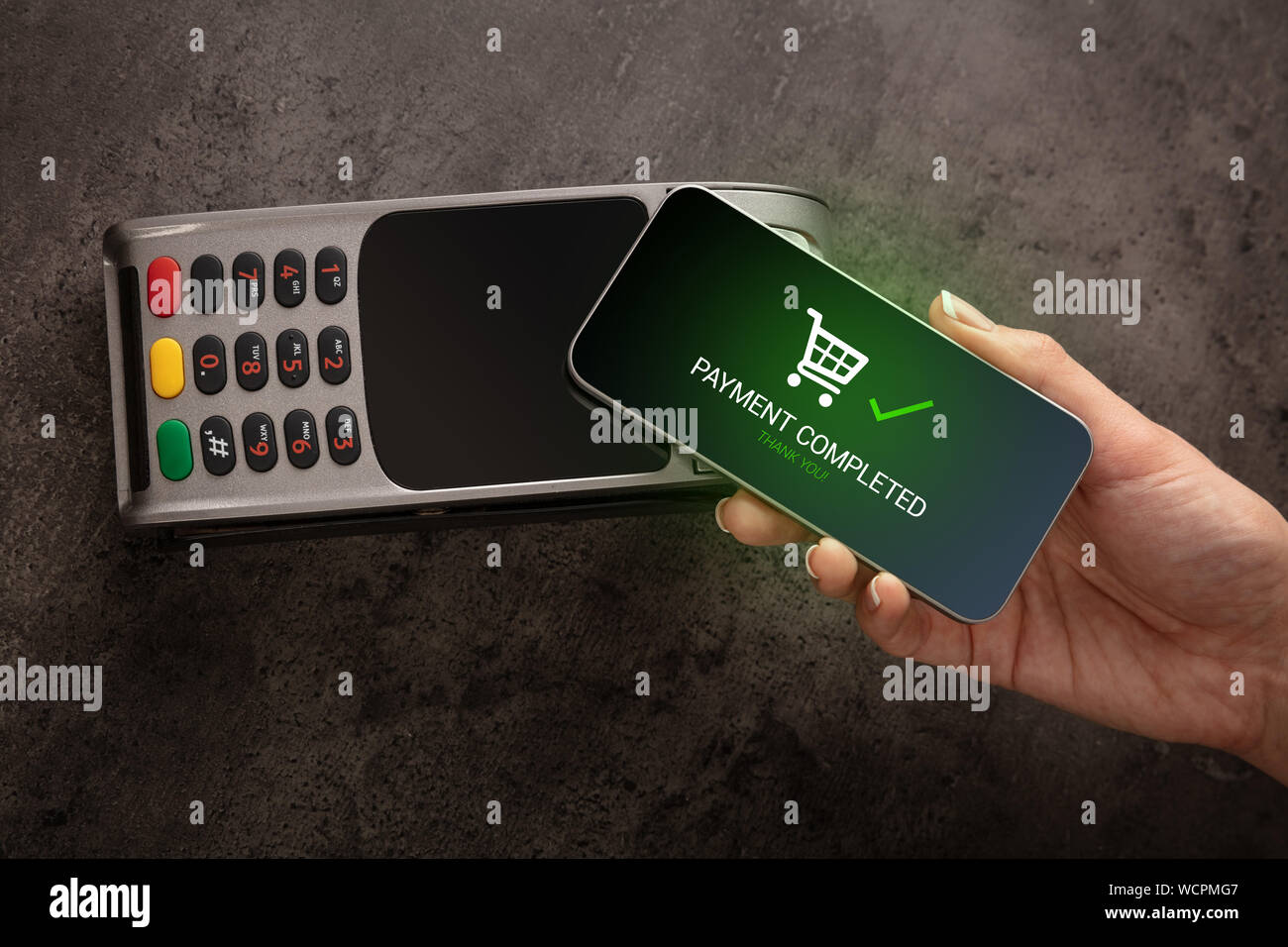 Mobile payment accepted on terminal Stock Photo - Alamy