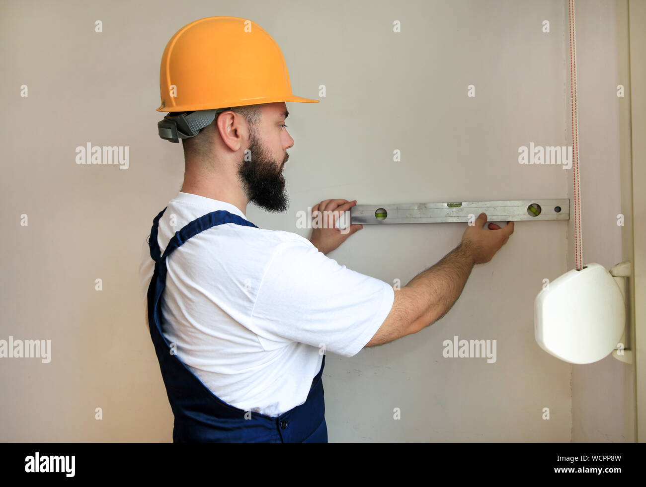 Construction worker and handyman is working on renovation of apartment ...