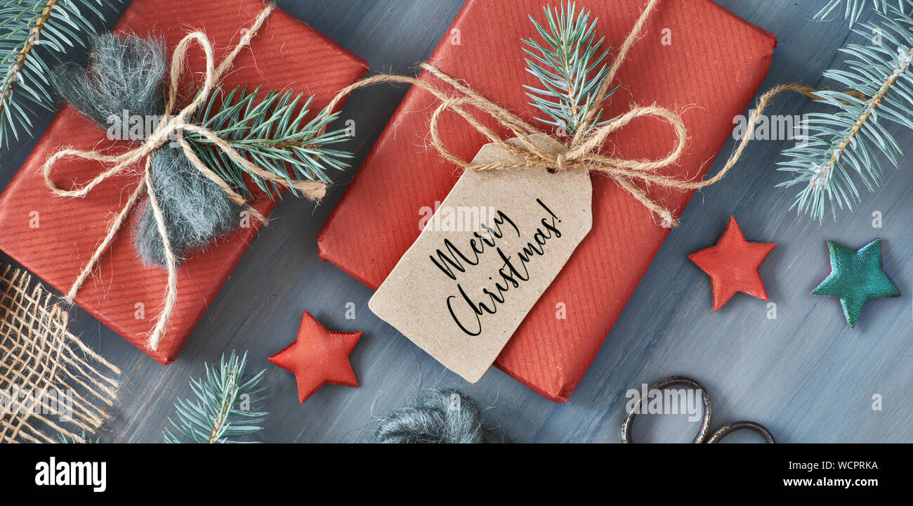 Rustic wooden background with fir branches and Christmas presents gift ...