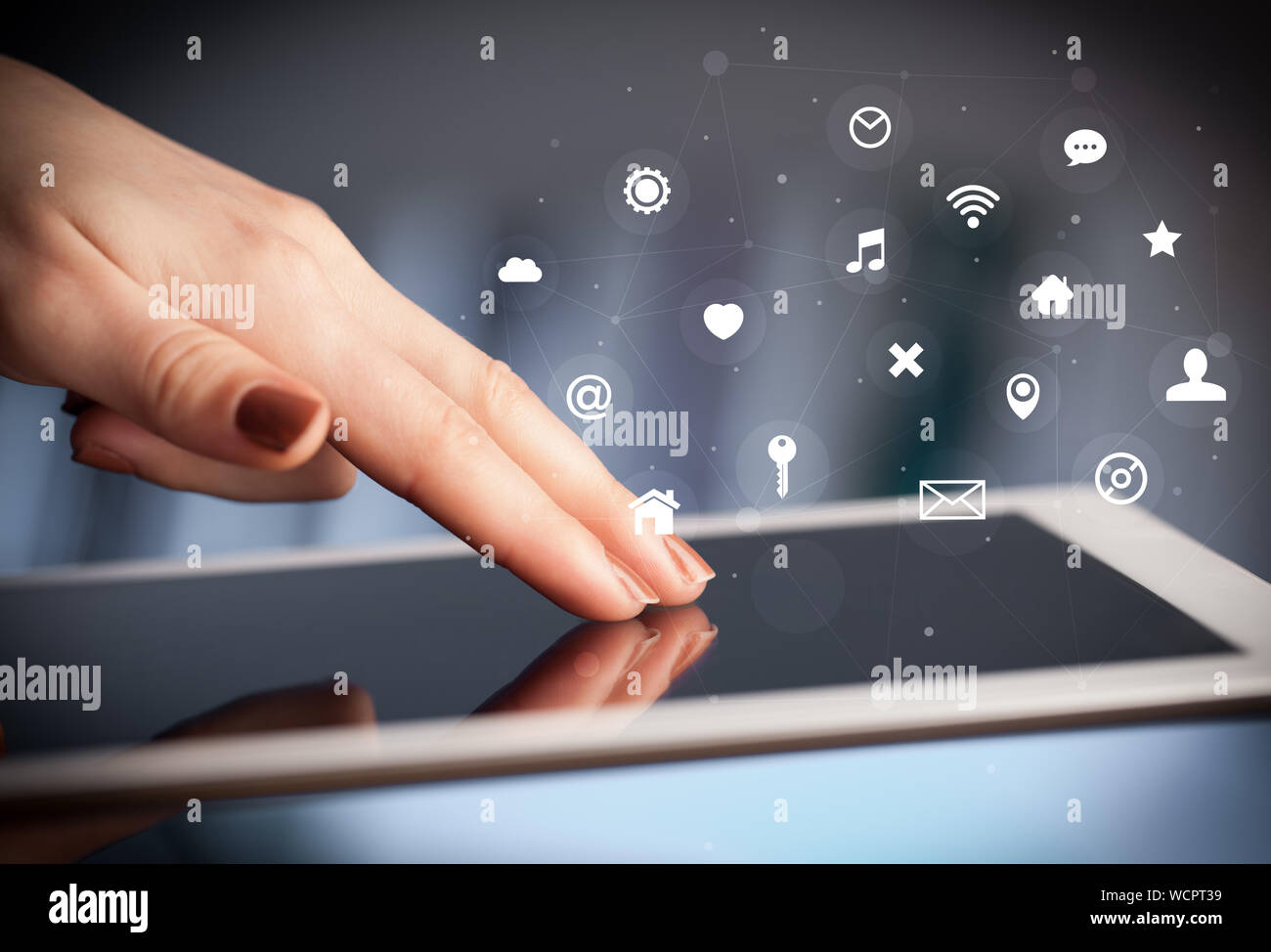 Hand holding tablet with multimedia and application symbols concept ...