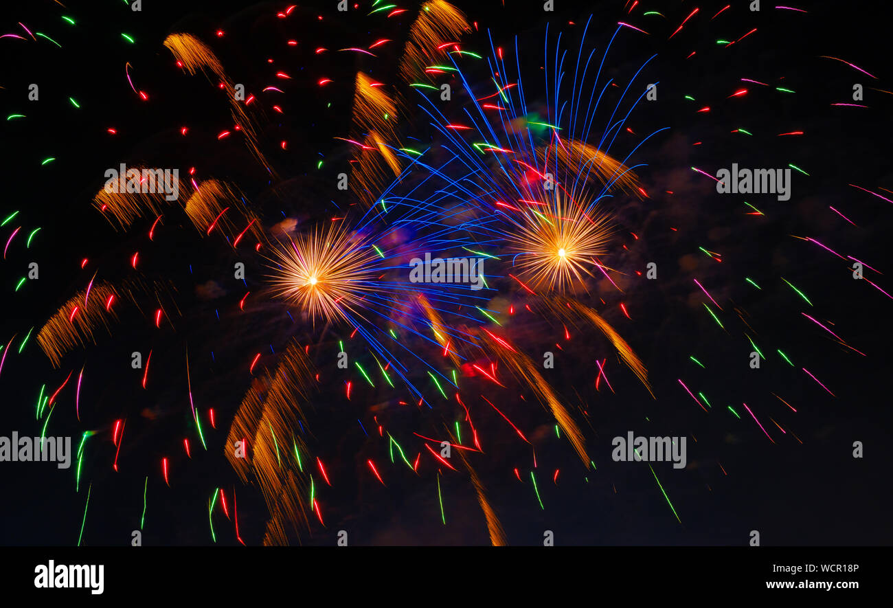 Colorful fireworks in night sky background Stock Photo - Alamy