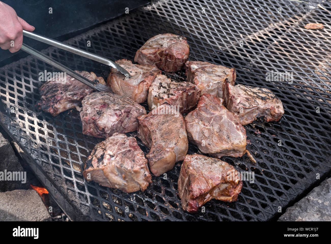 Cooking pork loin over a fire at the Minam River Lodge in Oregon's ...