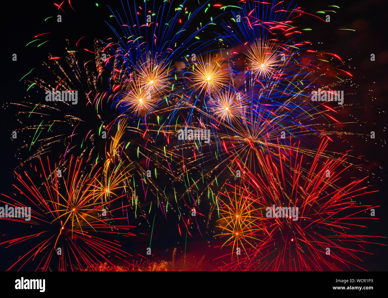 Colorful fireworks in night sky background Stock Photo - Alamy