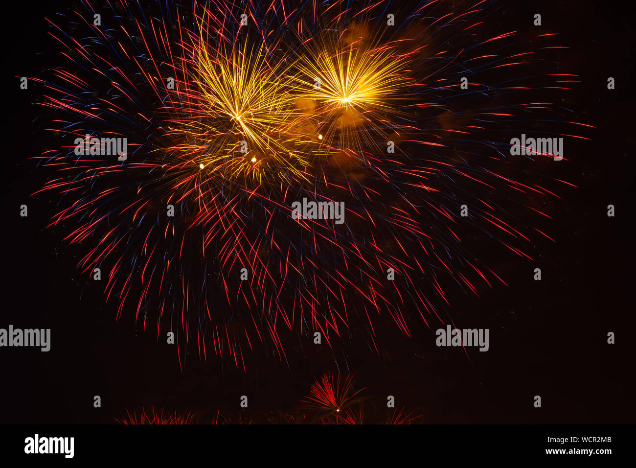 Colorful fireworks in night sky background Stock Photo - Alamy