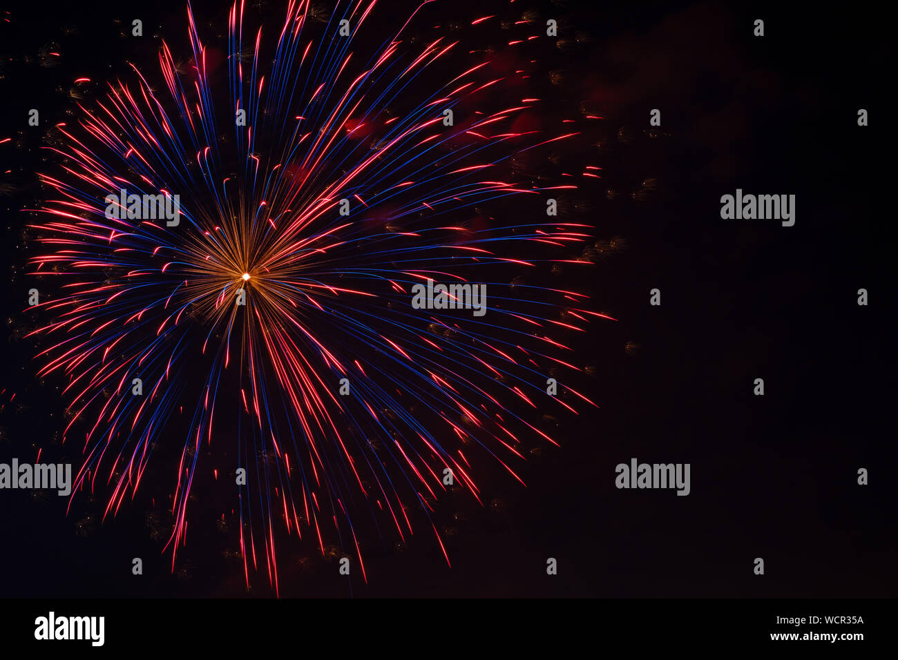 Colorful fireworks in night sky background Stock Photo - Alamy