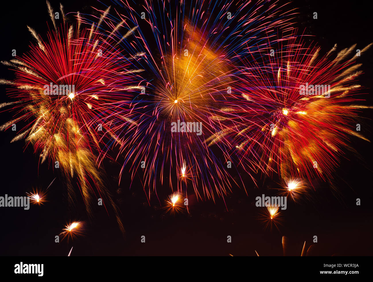 Colorful fireworks in night sky background Stock Photo - Alamy