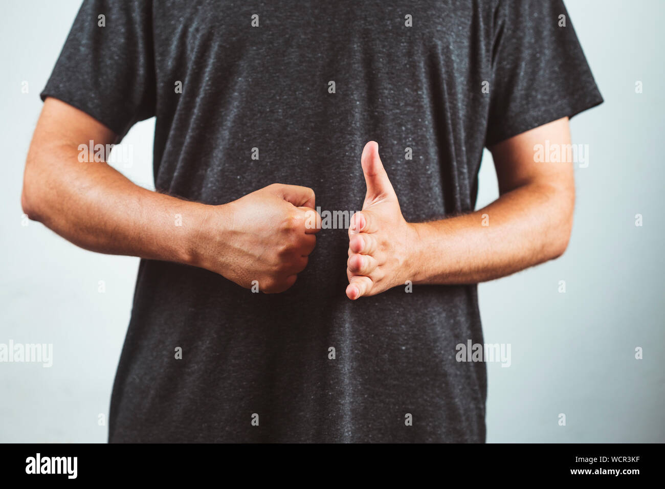 young man striking a fist against the palm of the other hand - Fist ...