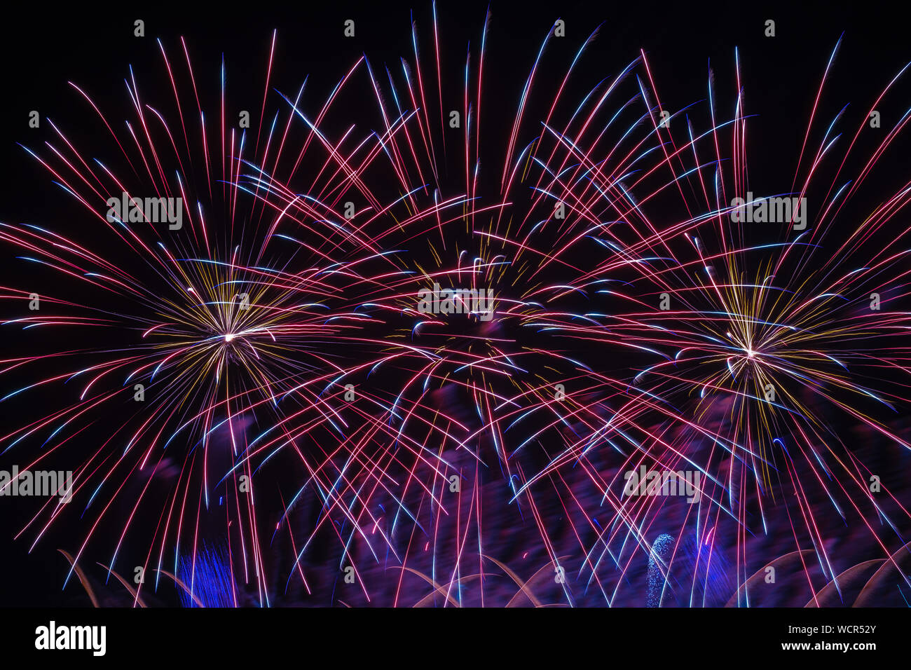 Colorful fireworks in night sky background Stock Photo - Alamy