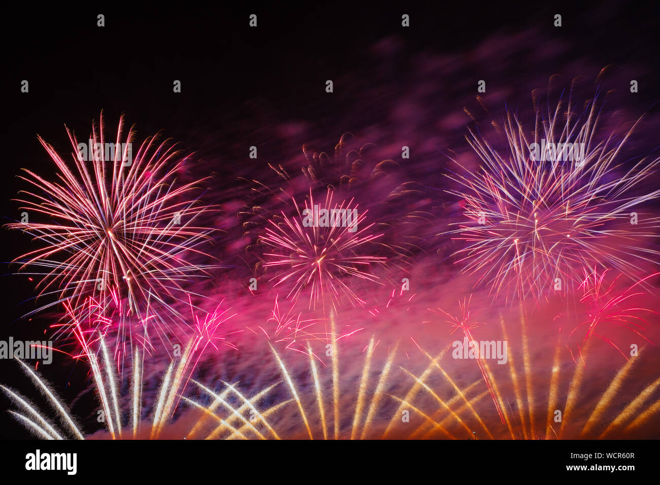 Colorful fireworks in night sky background Stock Photo - Alamy