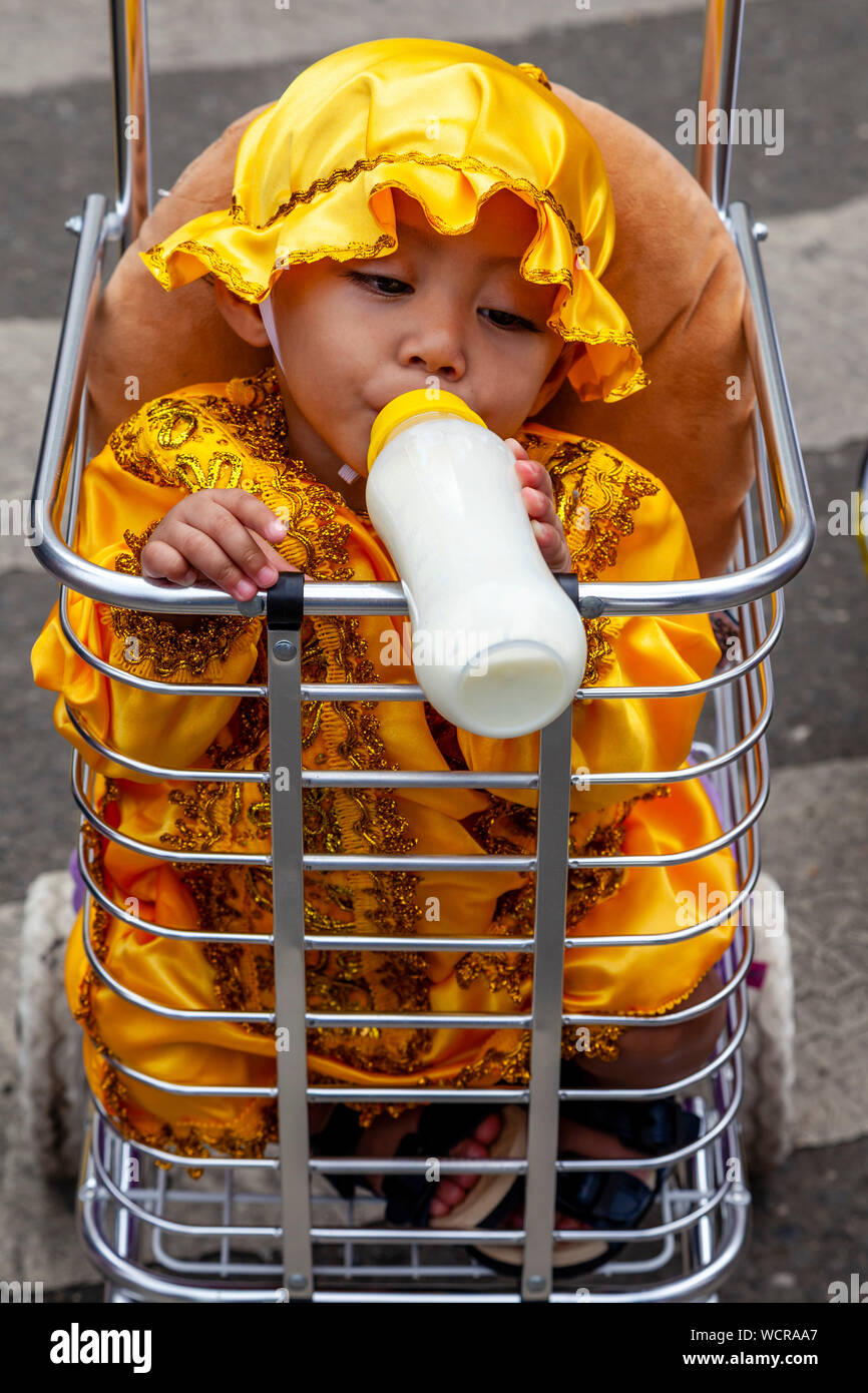 A Child Sits In A Trolley With A Bottle Of Milk During The Fluvial ...