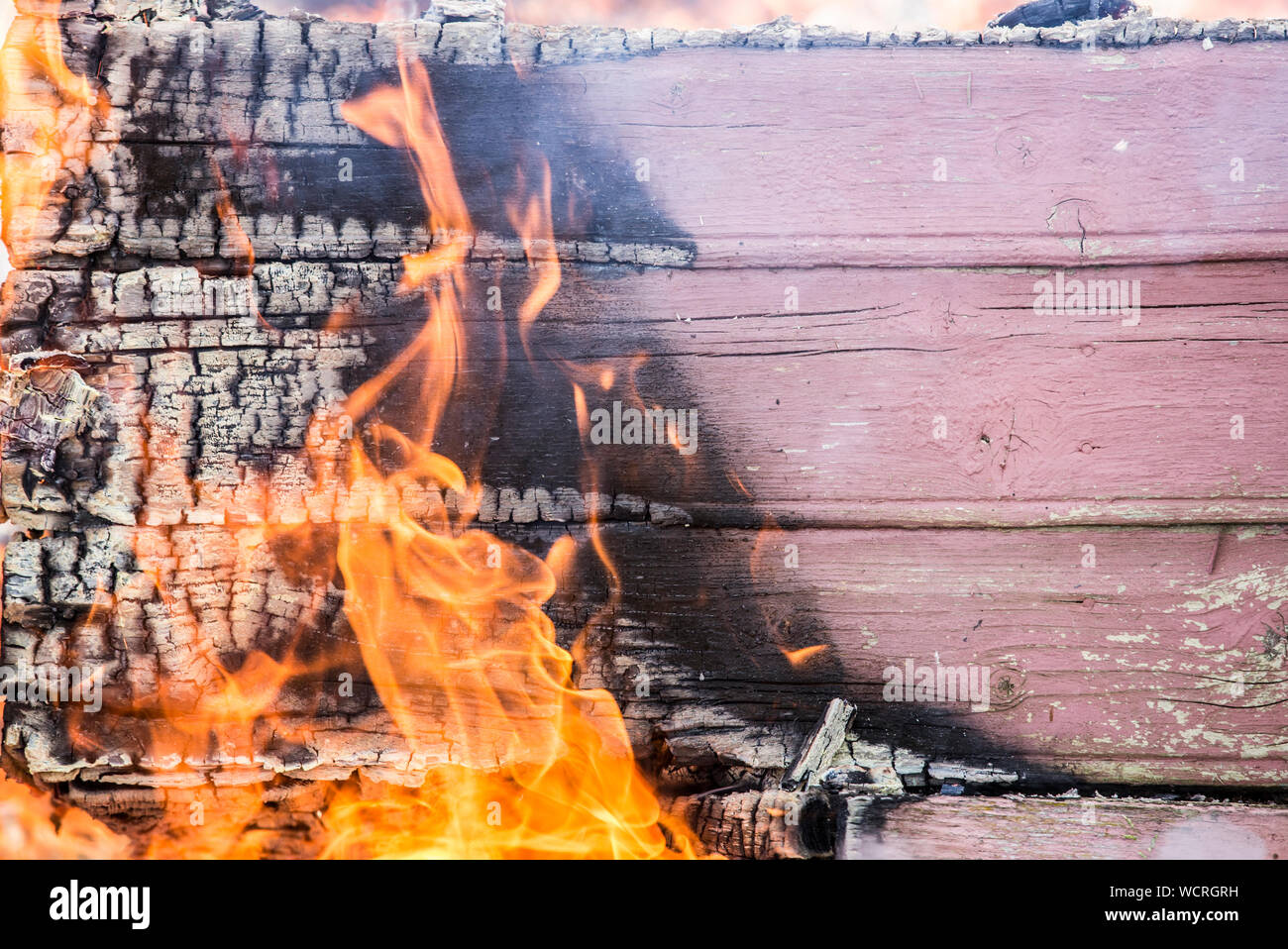 Detail view of burning painted wooden board wall fallen apart, lot of ...