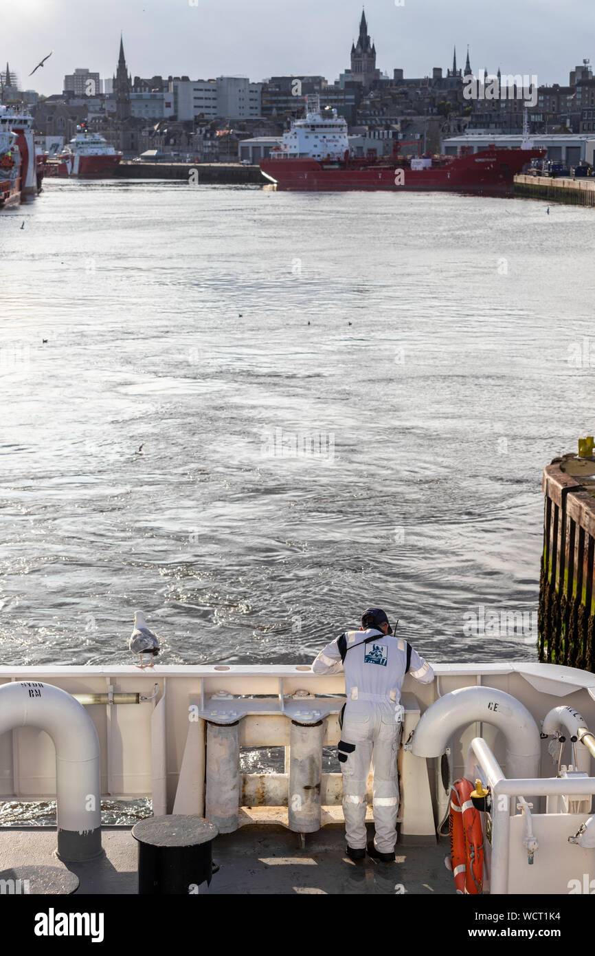 Ferry worker checking room clearance, Harbour of Aberdeen from ferry ...