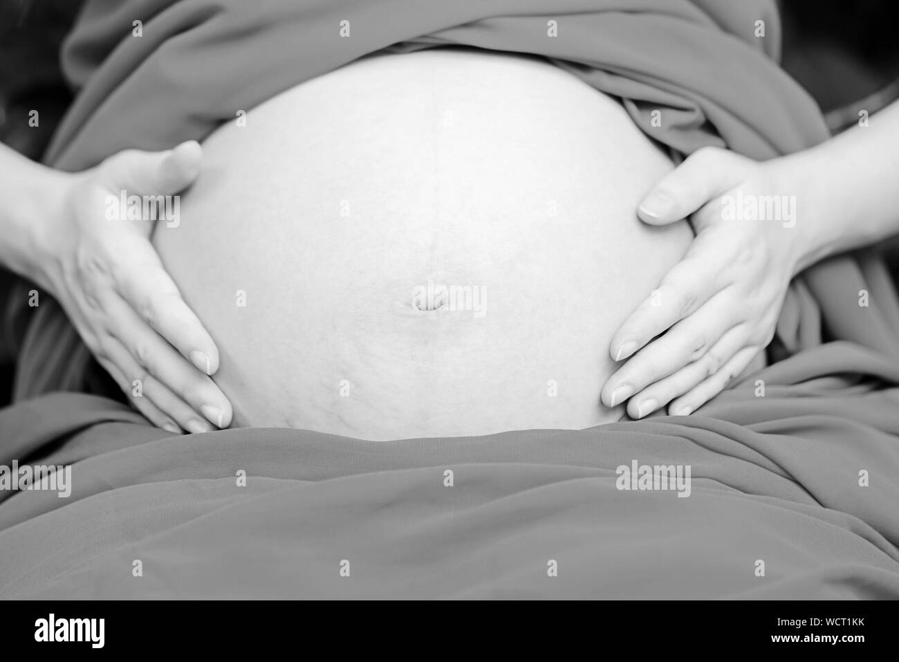 Woman with hands on her stomach hi-res stock photography and images - Alamy