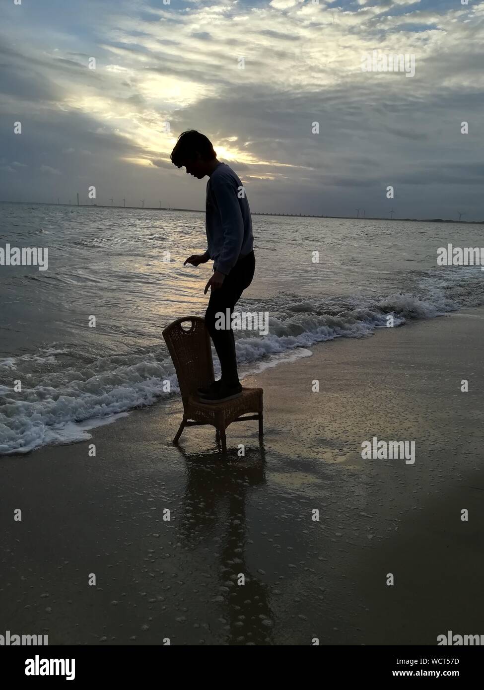 Boy standing on chair hi-res stock photography and images - Alamy