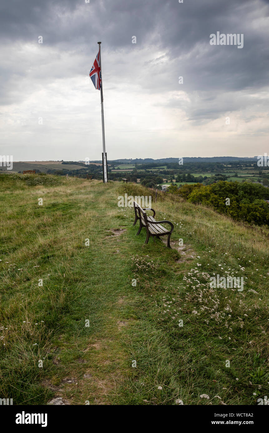 The Union Jack flag and wooden bench on the top of Castle Hill, Mere ...