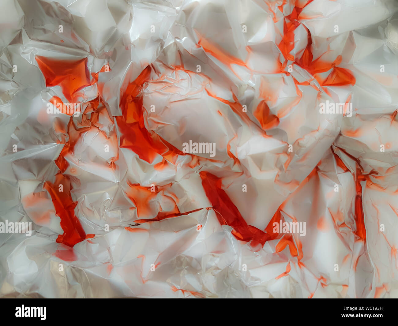 Red paint on crumpled foil with blur Stock Photo - Alamy